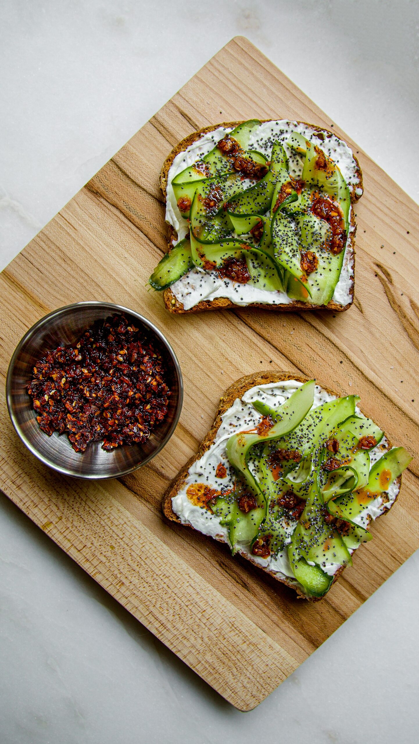 Cucumber Toast with Cream Cheese + Chili Crisp - The Plant Collective