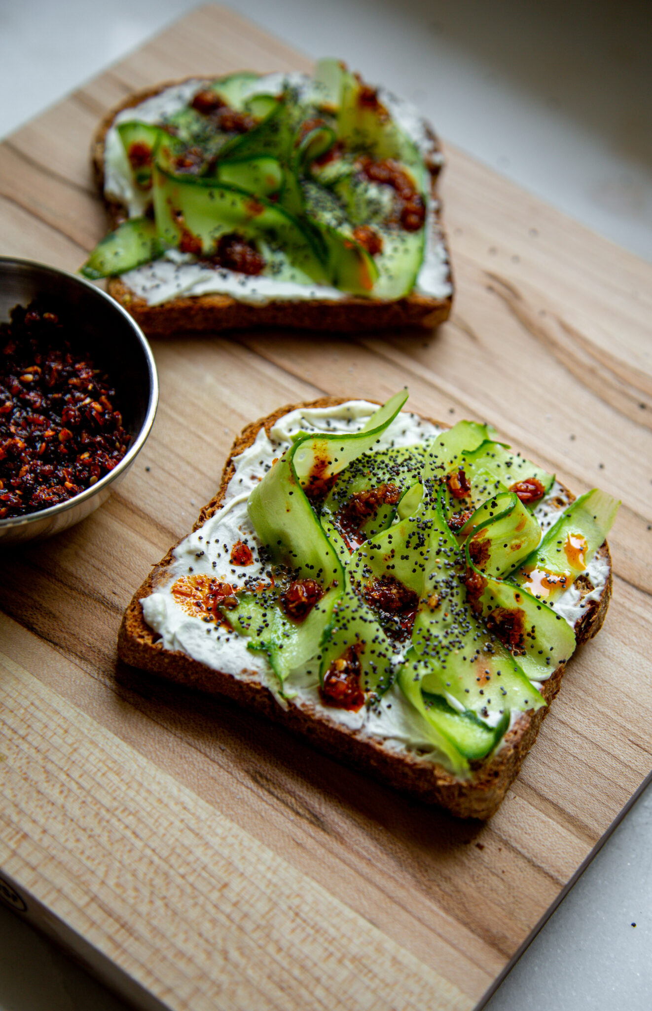 Cucumber Toast with Cream Cheese + Chili Crisp - The Plant Collective